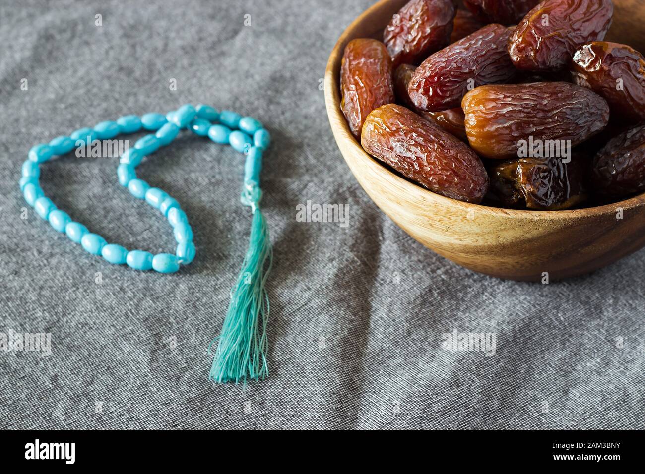 Fresh dates Medjool in wooden bowl in upper right corner and blue ...