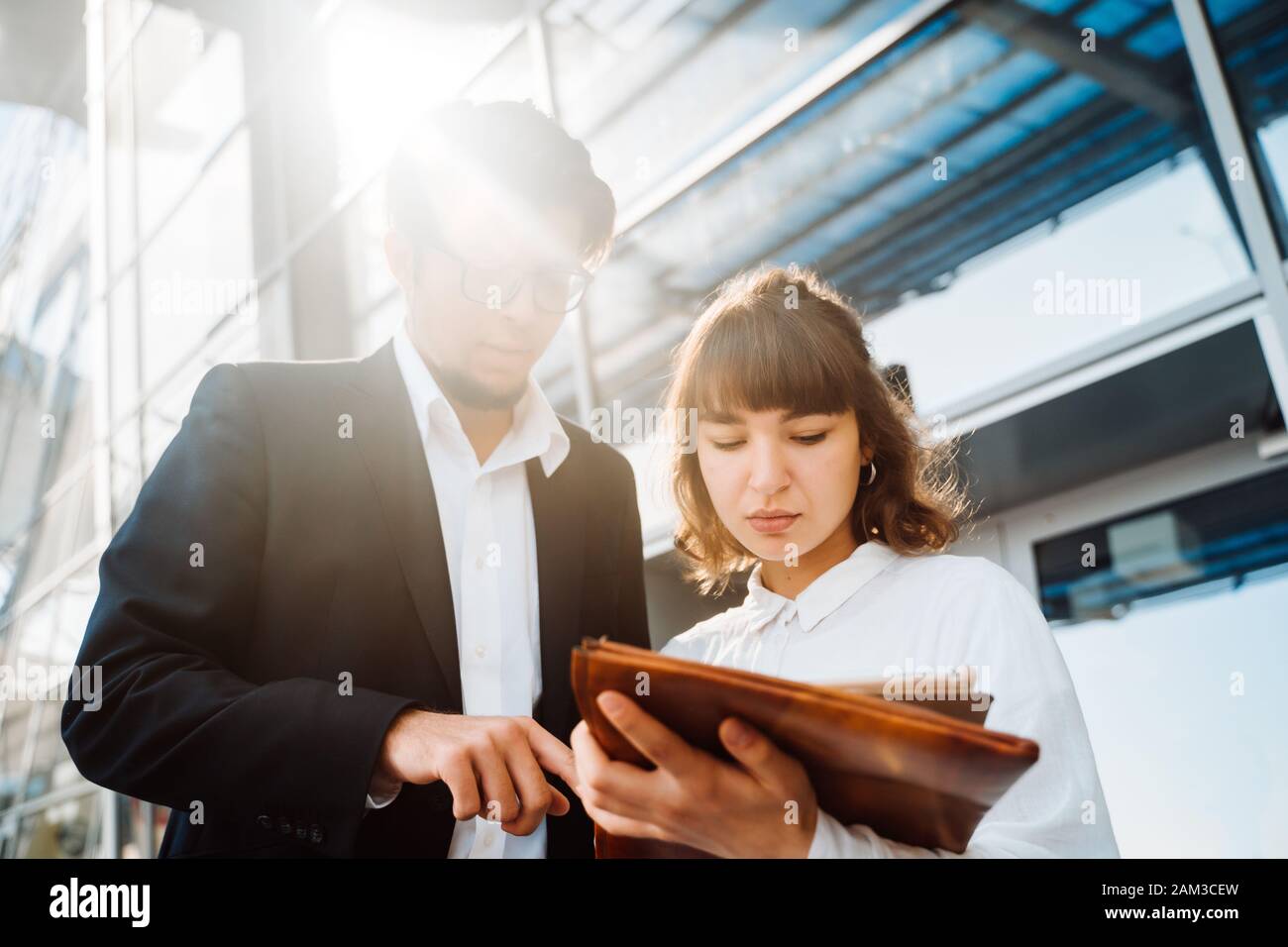 Businessman and businesswoman look at important papers Stock Photo - Alamy