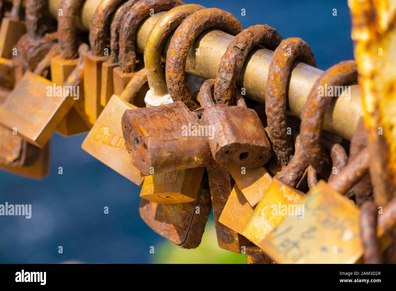 Rusty padlocks locked on a rail for good luck Stock Photo - Alamy