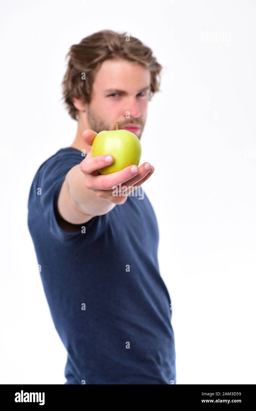 Man with bristle holds apple. Guy in blue tshirt isolated on white ...