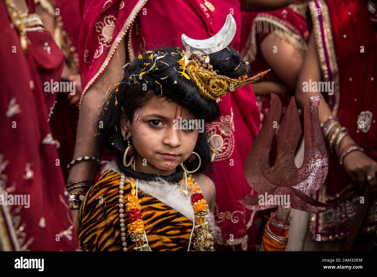 Kid holding Shiva trident during Holi celebration. Mathura, India Stock ...