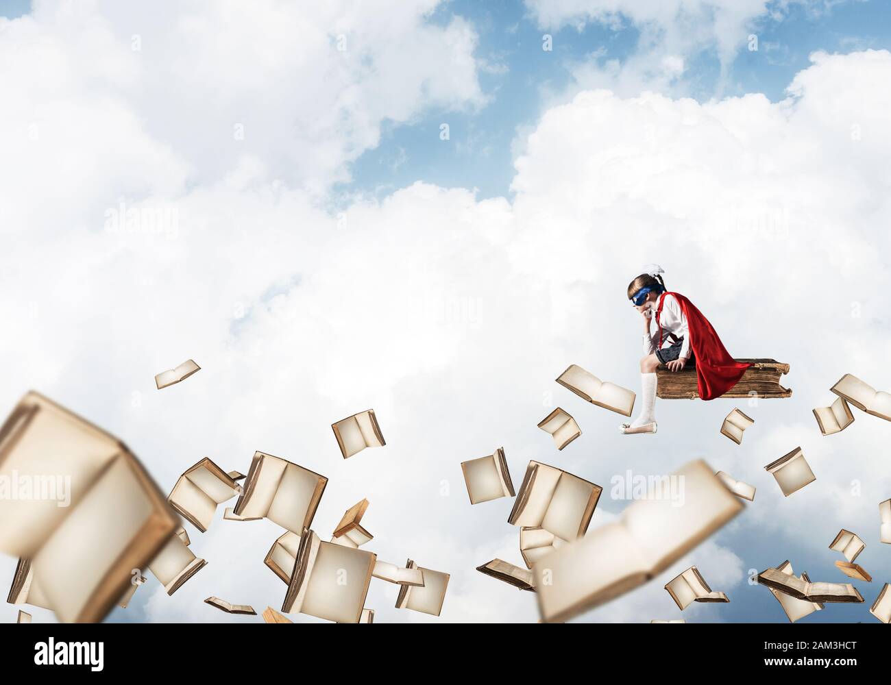 Girl power concept with cute kid guardian against cloudscape background ...