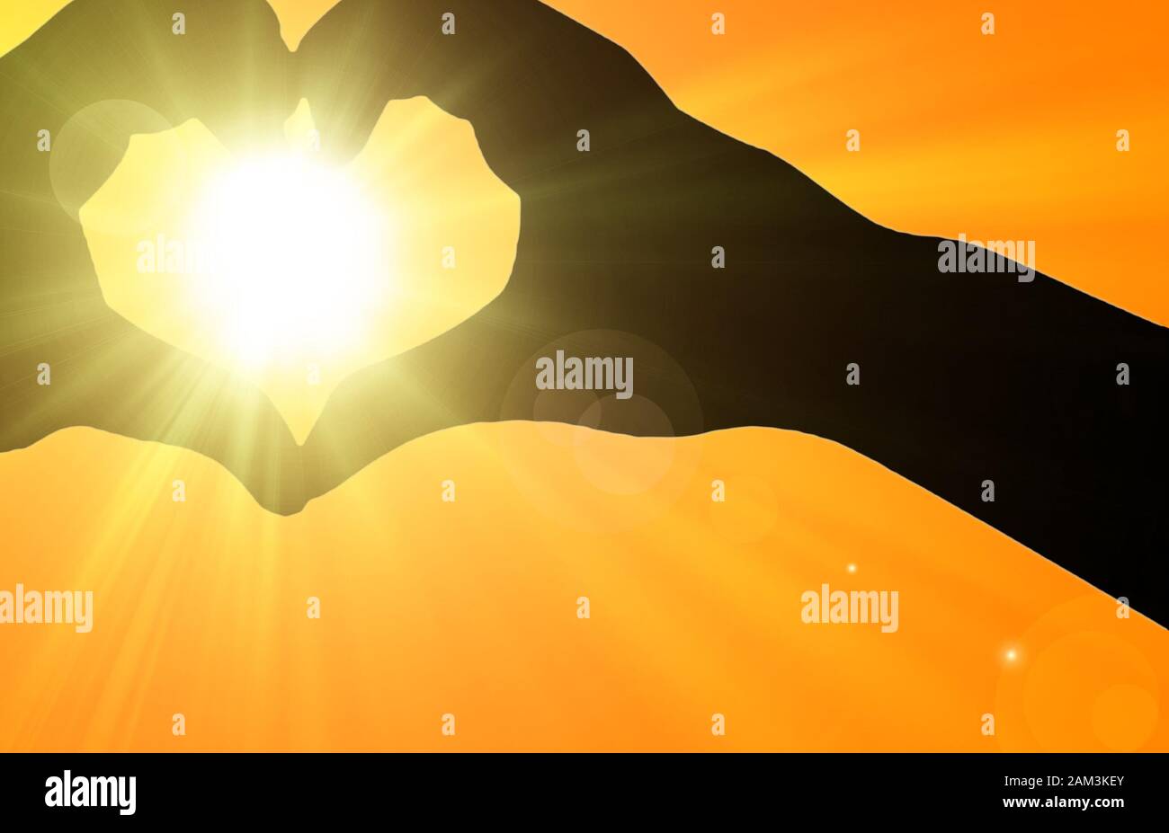 silhouette of two hands forming a heart with the sun's rays crossing it ...