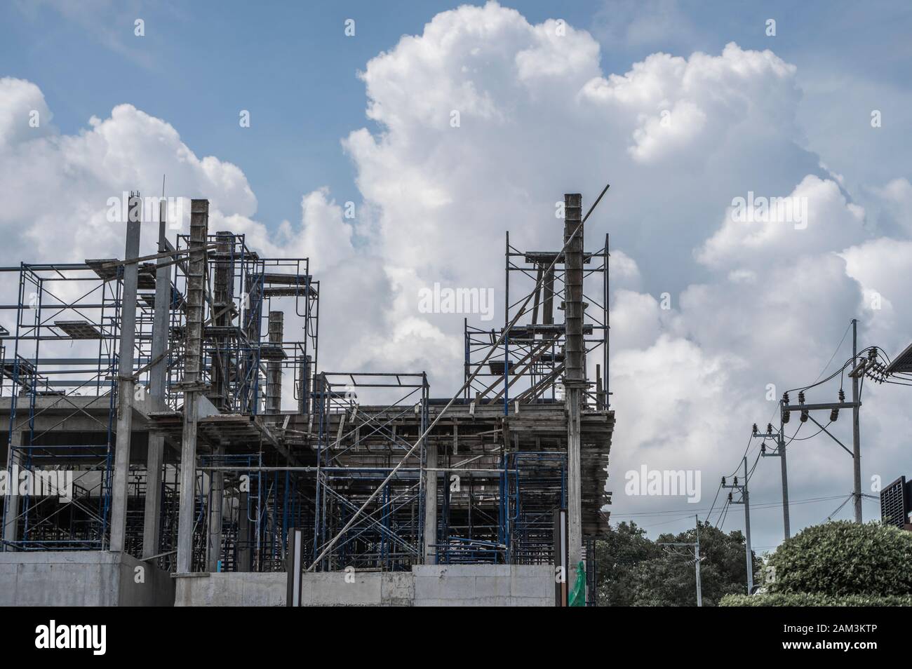 Building and Construction Site in progress. Building construction site against cloudy sky. Metal ...