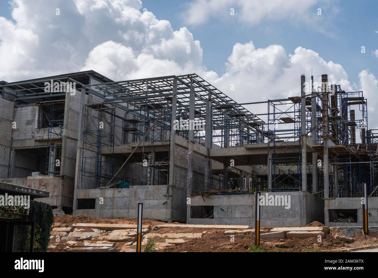 Building and Construction Site in progress. Building construction site against cloudy sky. Metal ...