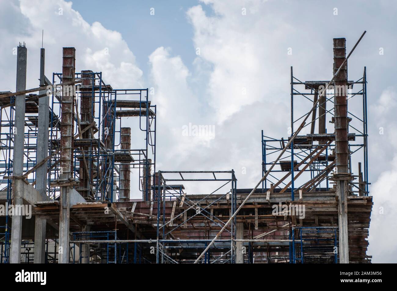 Building and Construction Site in progress. Building construction site against cloudy sky. Metal ...