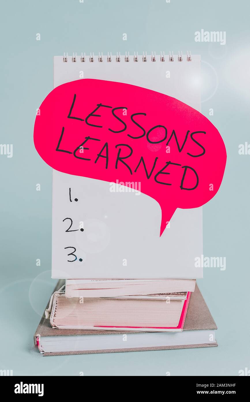 Writing note showing Lessons Learned. Business concept for the knowledge or understanding gained ...