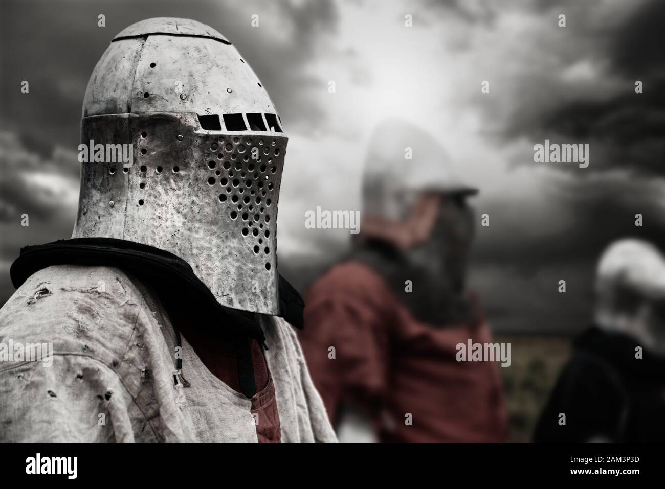 Side view of medieval knight in iron helmet posing. Selective focus of ...