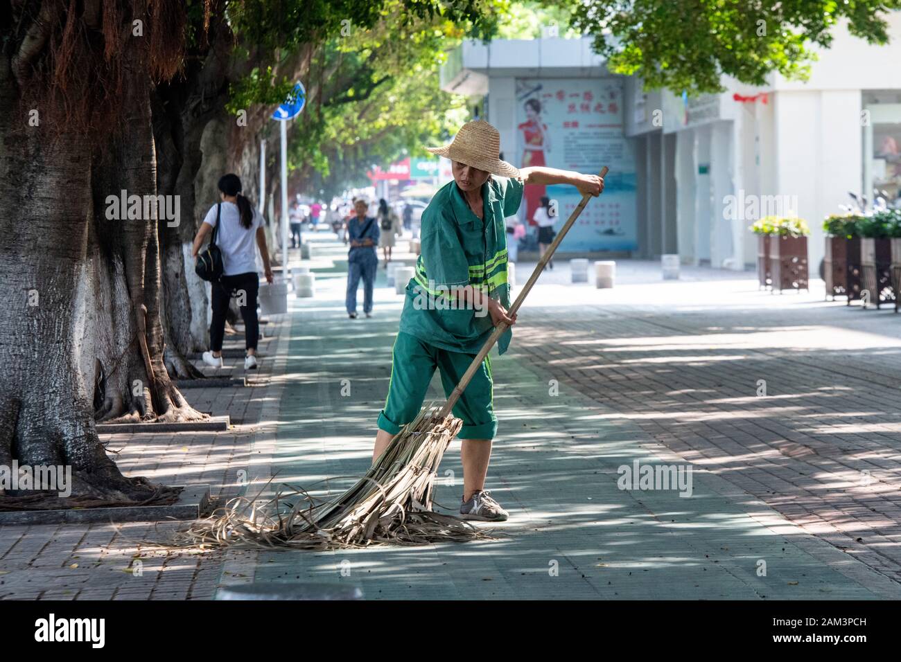 A female street sweeper in the Chinese city of Zhaoqing Stock Photo - Alamy