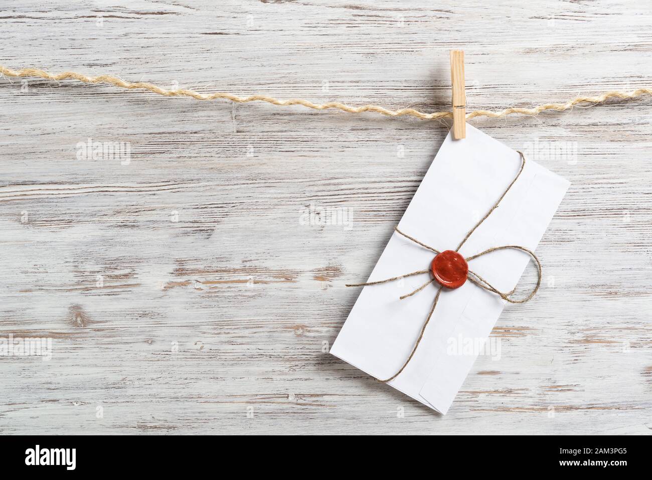 White envelope hanging on rope Stock Photo - Alamy