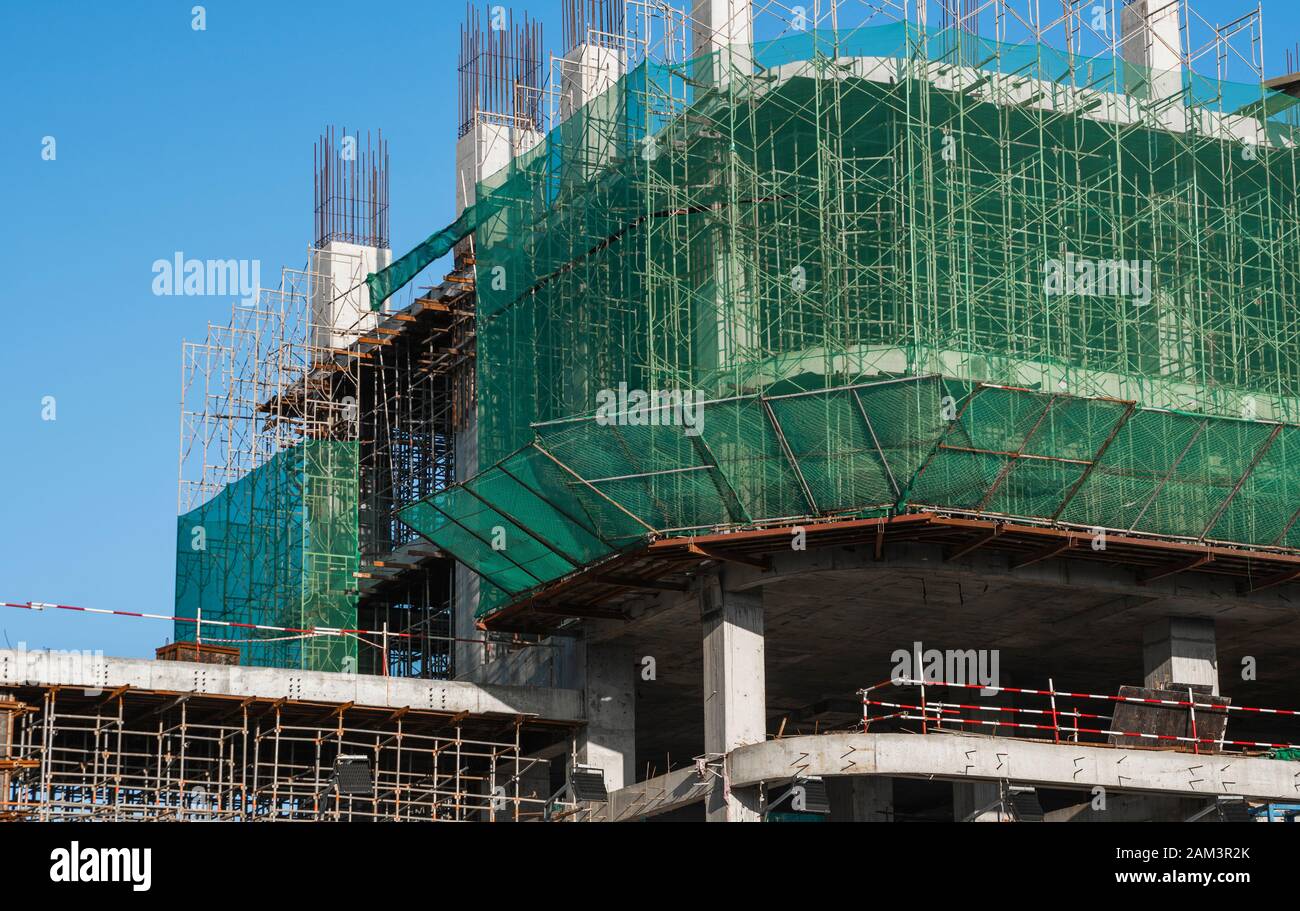 Building and Construction Site in progress. Building construction site against blue sky. Metal ...