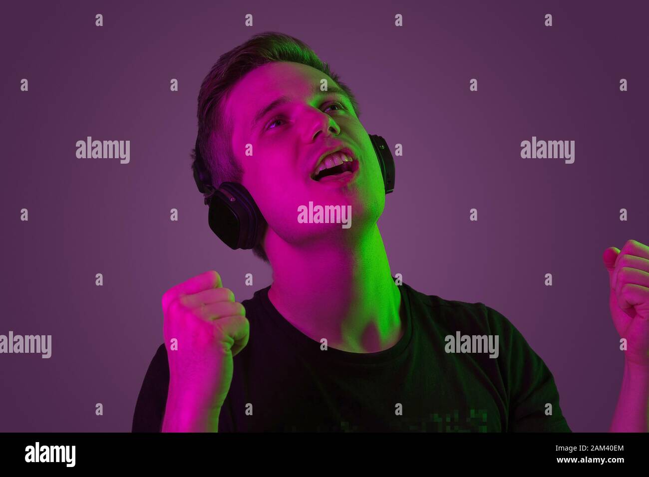 Listen to music, singing. Caucasian man's portrait isolated on purple ...