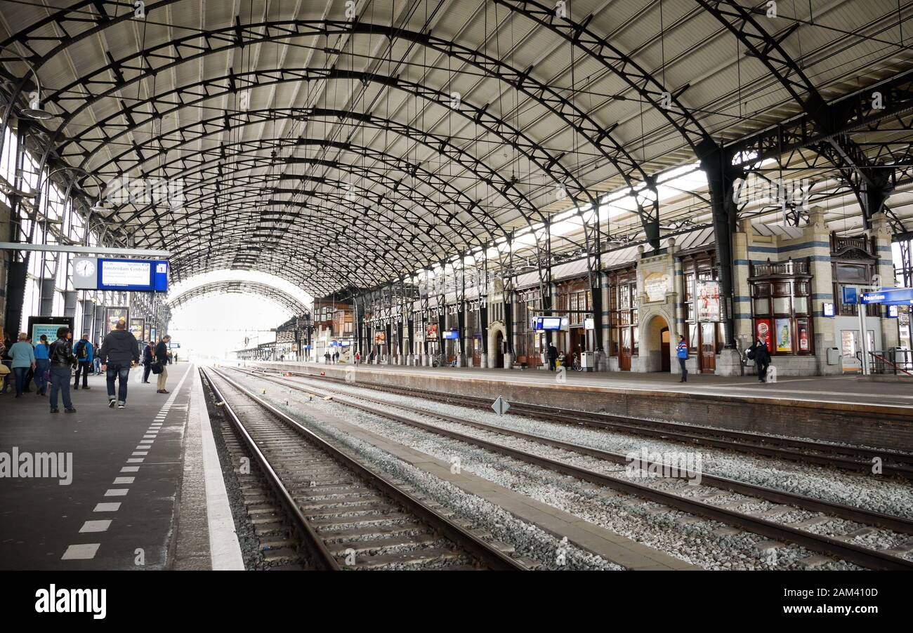 Haarlem train station, Netherlands. Travellers waiting on the platform ...