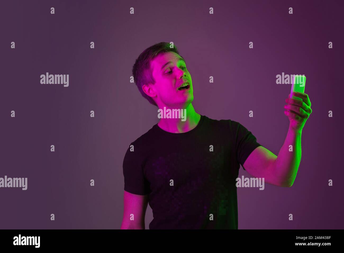 Using smartphone, taking selfie, vlog. Caucasian man's portrait on ...