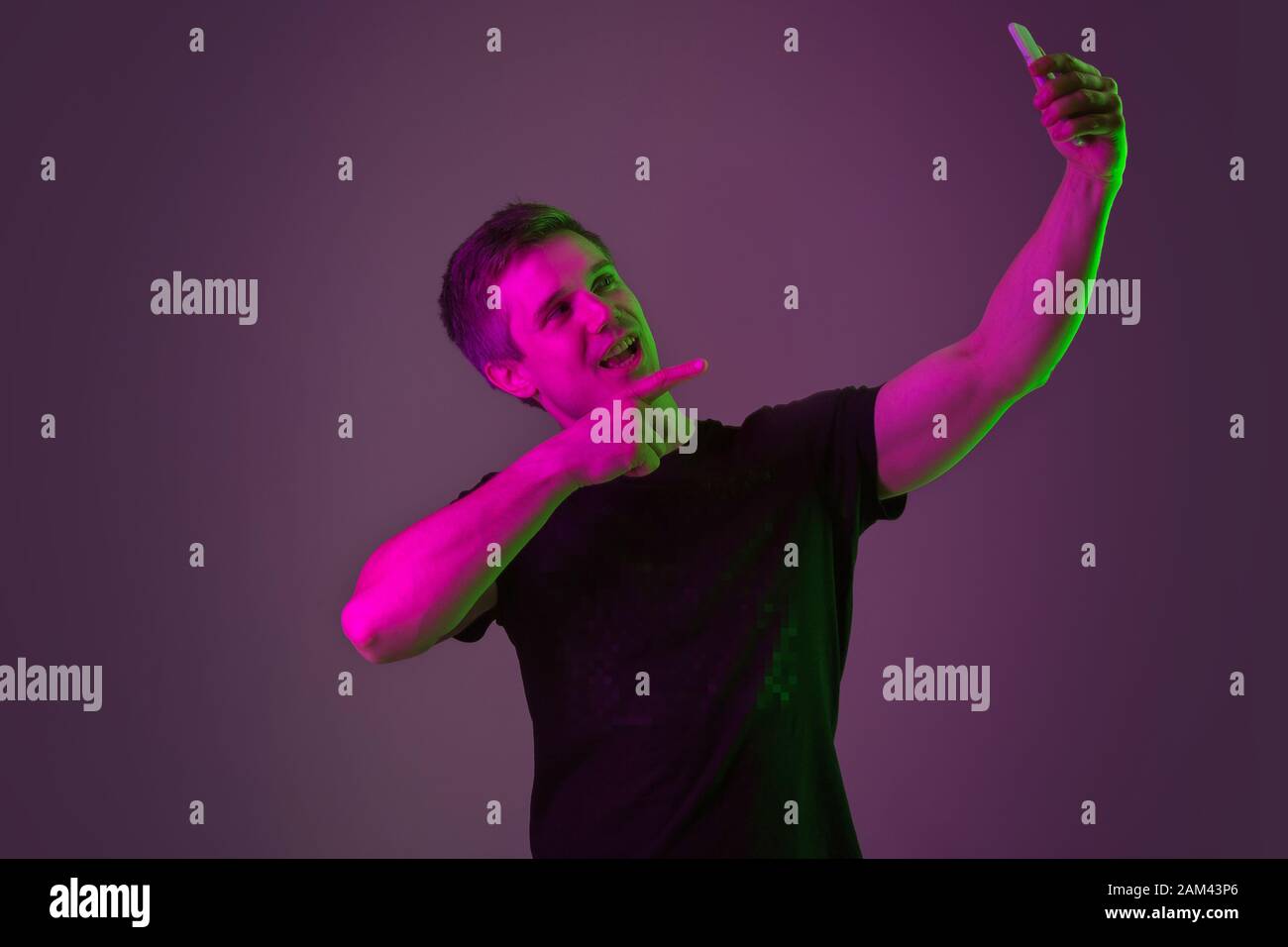 Using smartphone, taking selfie, vlog. Caucasian man's portrait on ...