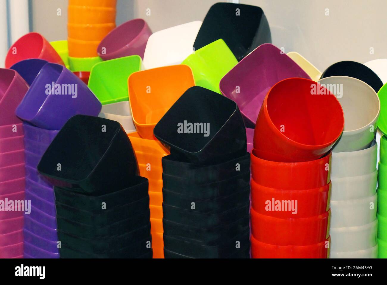 Empty colorful plastic flower pots stack in corner Stock Photo - Alamy