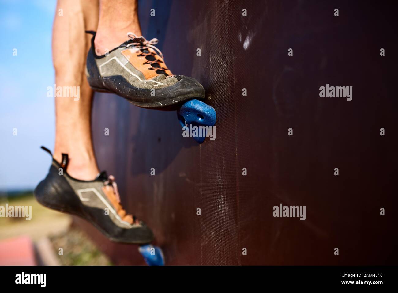 Bottom close up view of rock climber foot on training artificial ...
