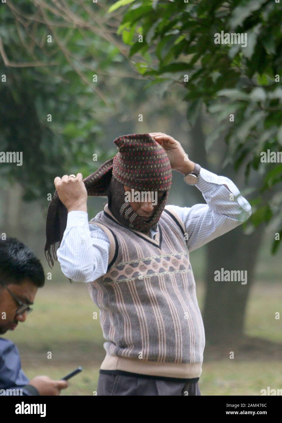 January 12, 2020, Dhaka, Bangladesh: A man wraps a piece of cloth ...