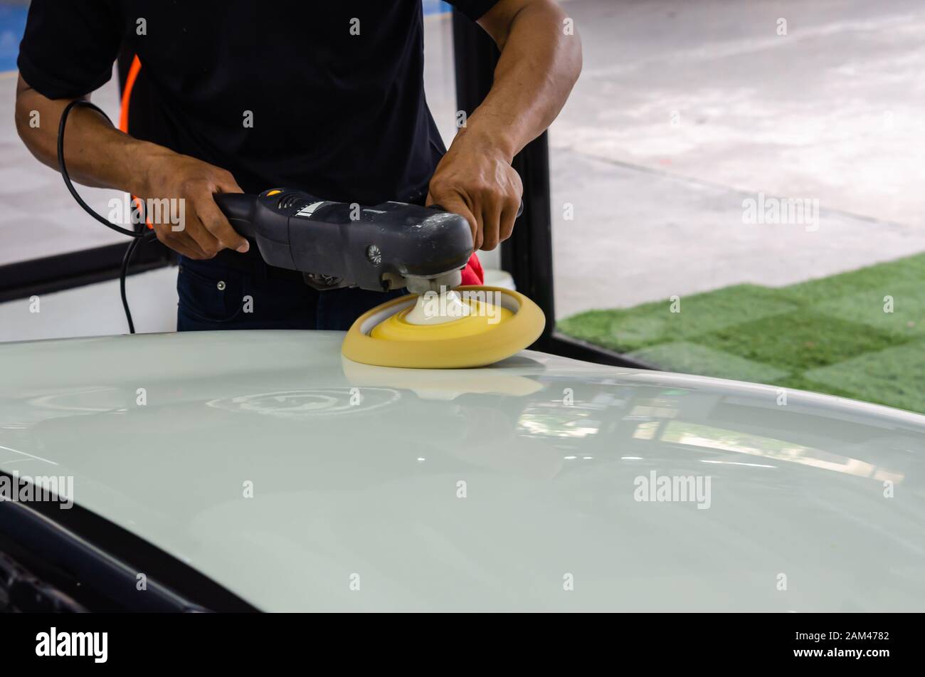 Man hands holding the work tool polish the car.Buffing and polishing ...