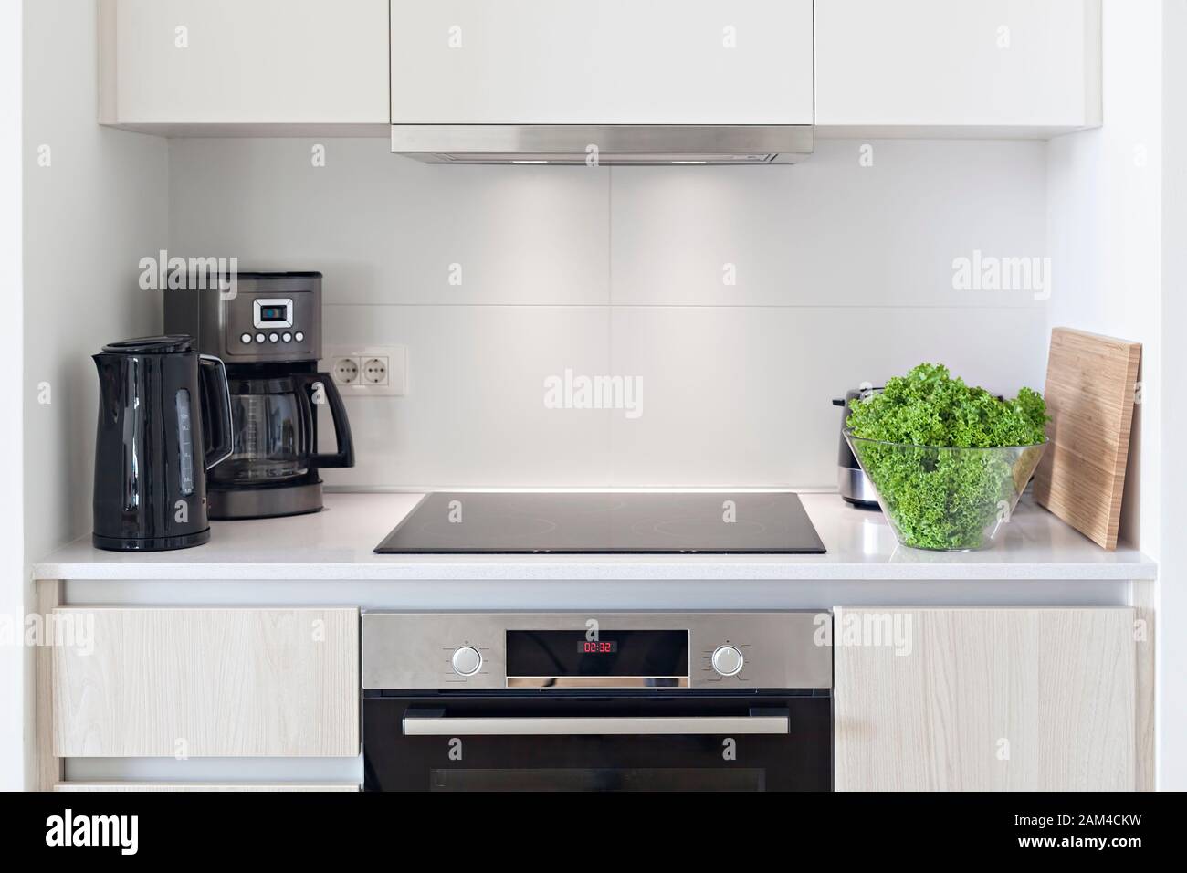 The interior of the kitchen with electric appliances, hood, kettler ...