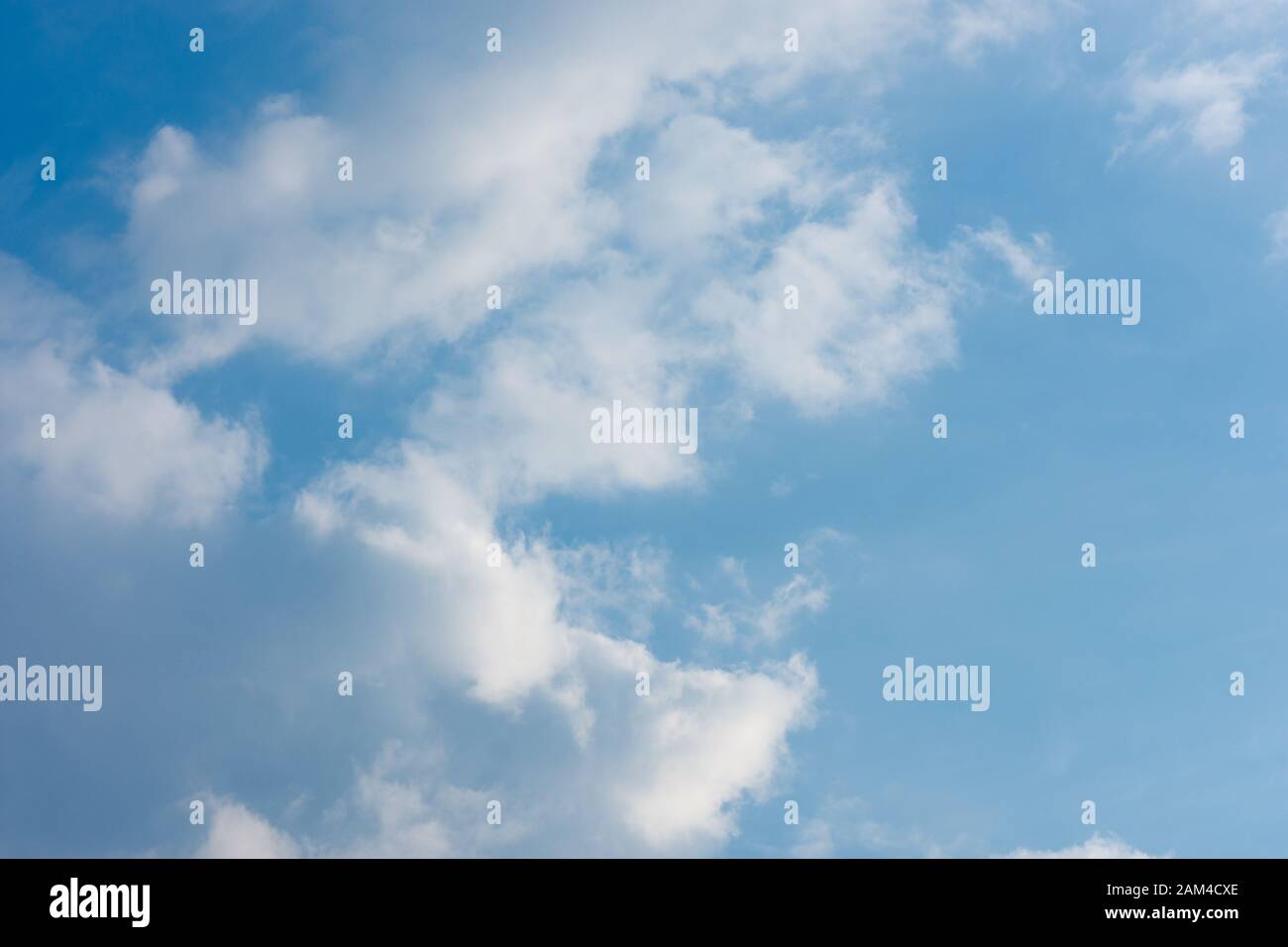 texture bright contrast sky with clouds and sun rays Stock Photo - Alamy
