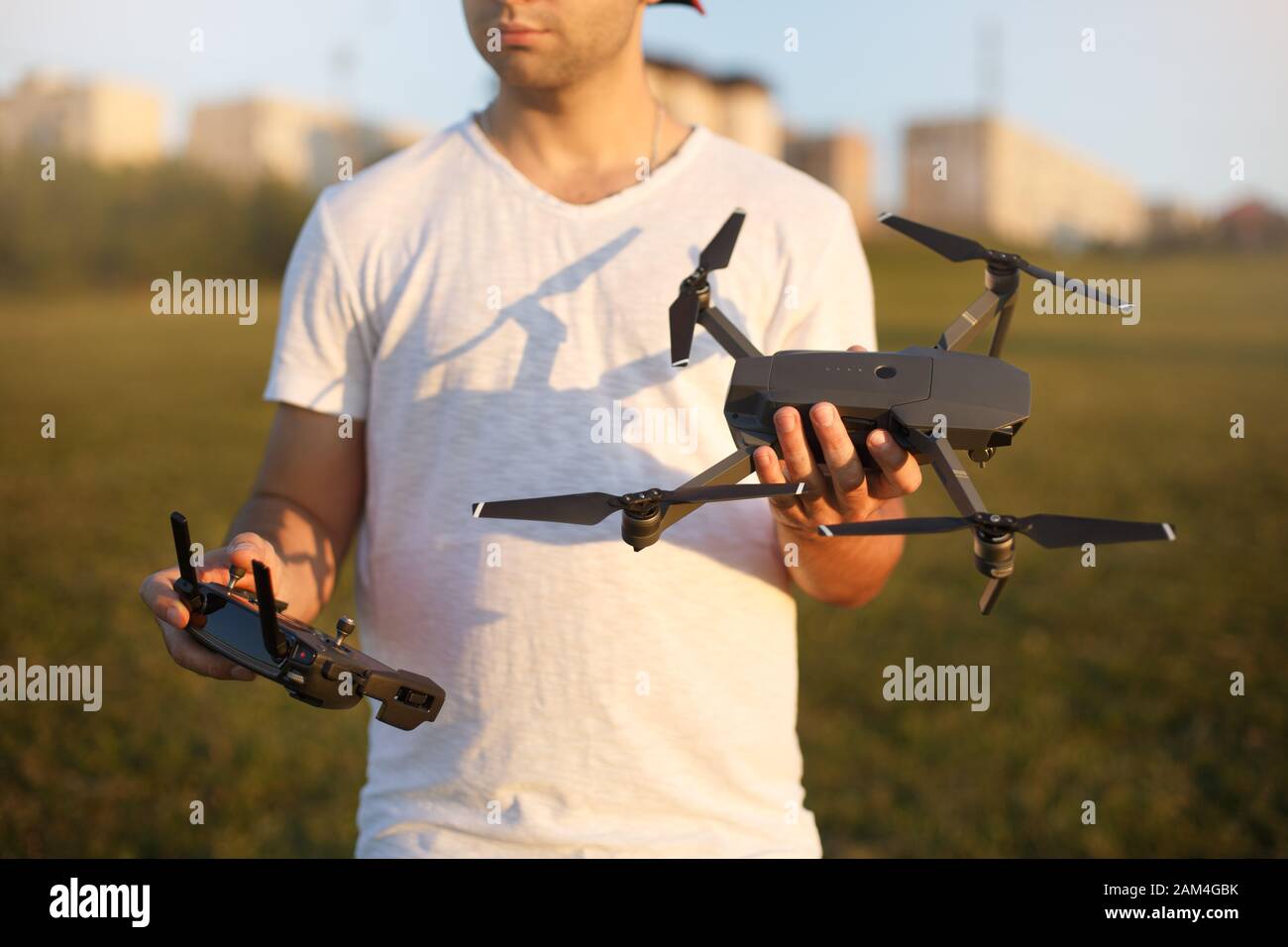 Happy man shows You small compact drone and remote controller. Pilot ...