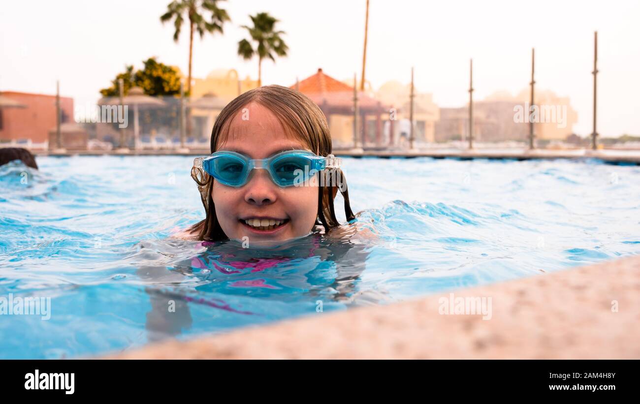 Underwater Young Girl Fun In The Swimming Pool With Goggles Summer