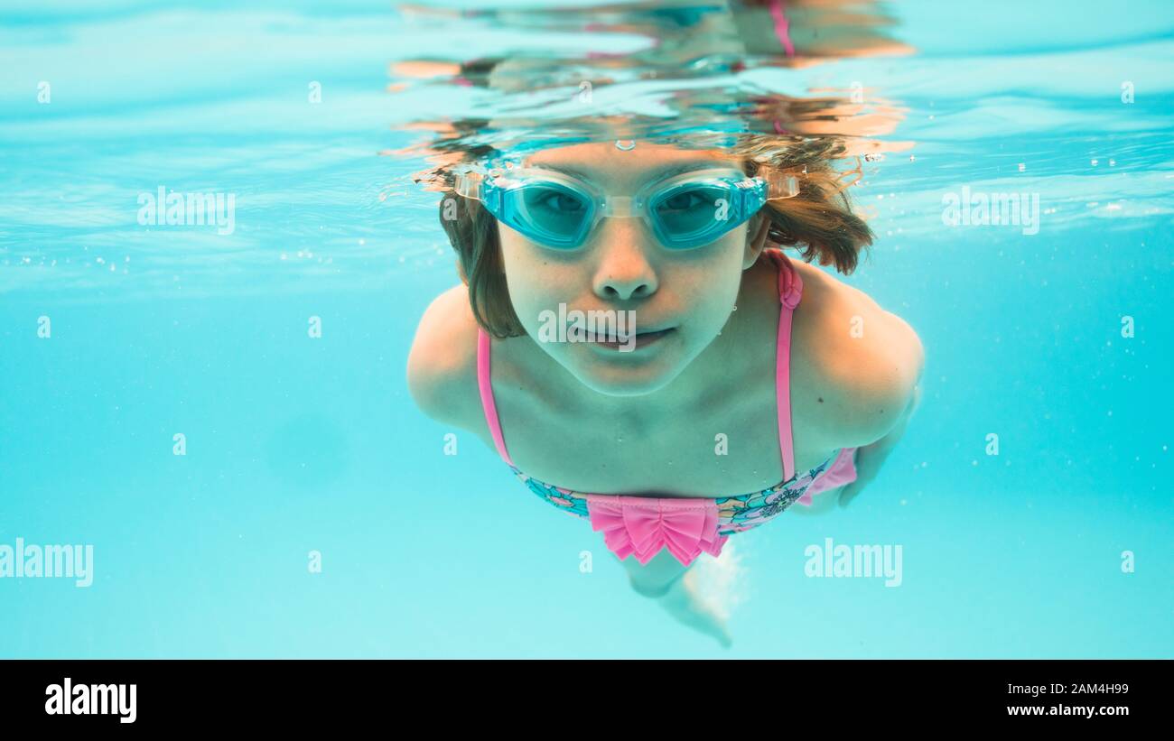 Underwater Young Girl Fun In The Swimming Pool With Goggles Summer