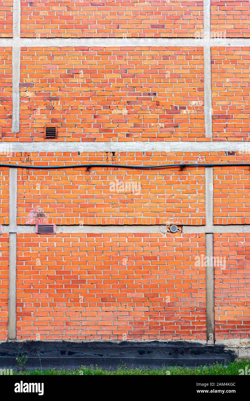 Red lined brick wall background with green grass Stock Photo - Alamy