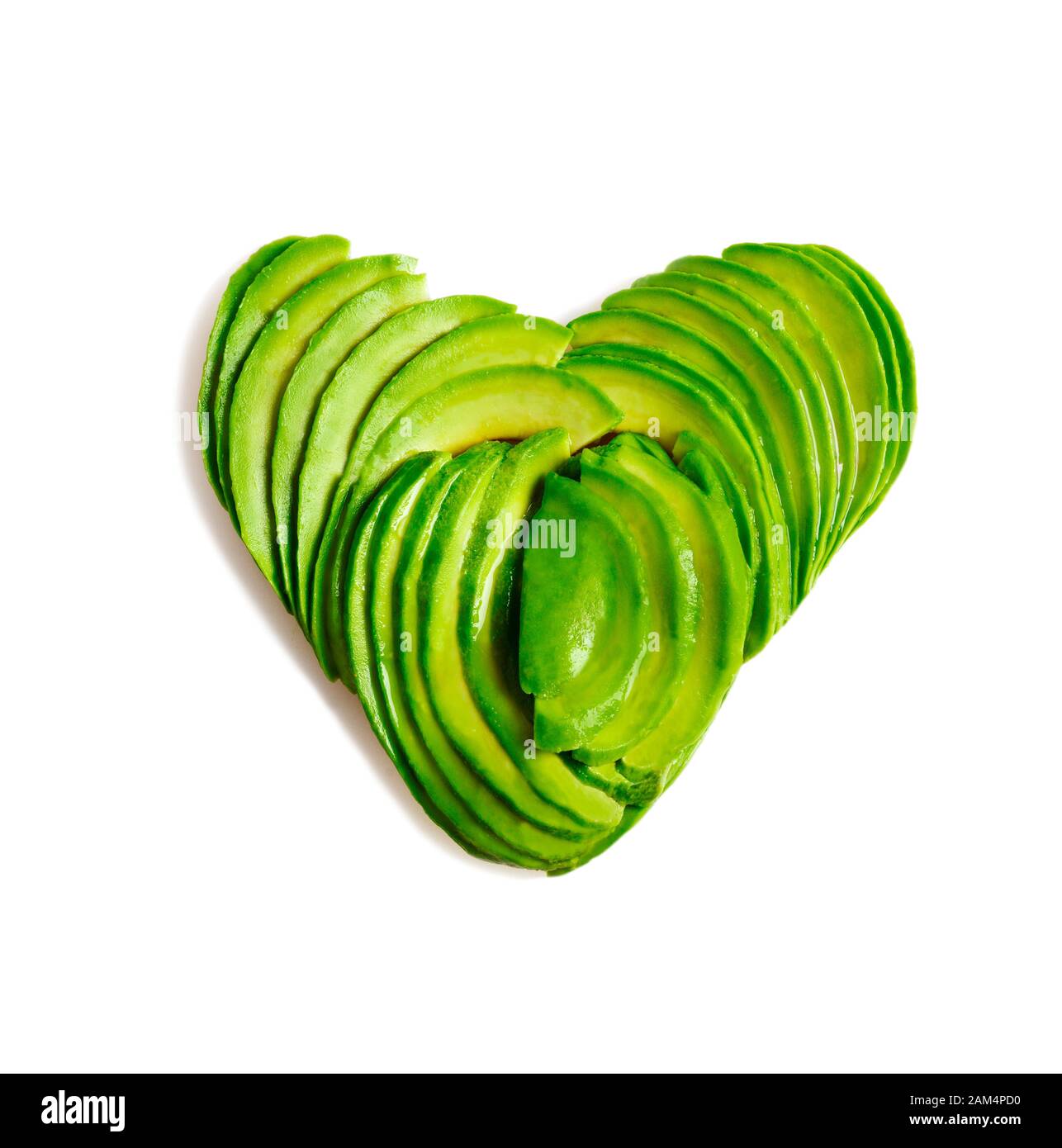 Sliced avocado in the shape of a heart isolated on white background ...