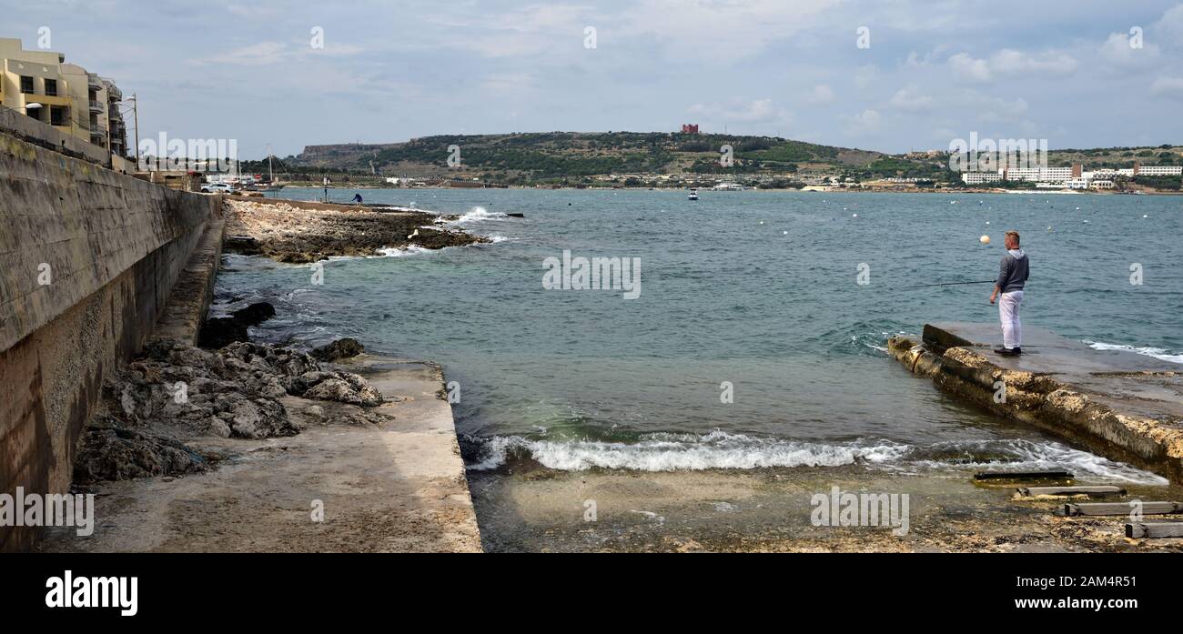 Mellieha, Malta - 13th October 2018:Lone fisherman fishing alongside ...
