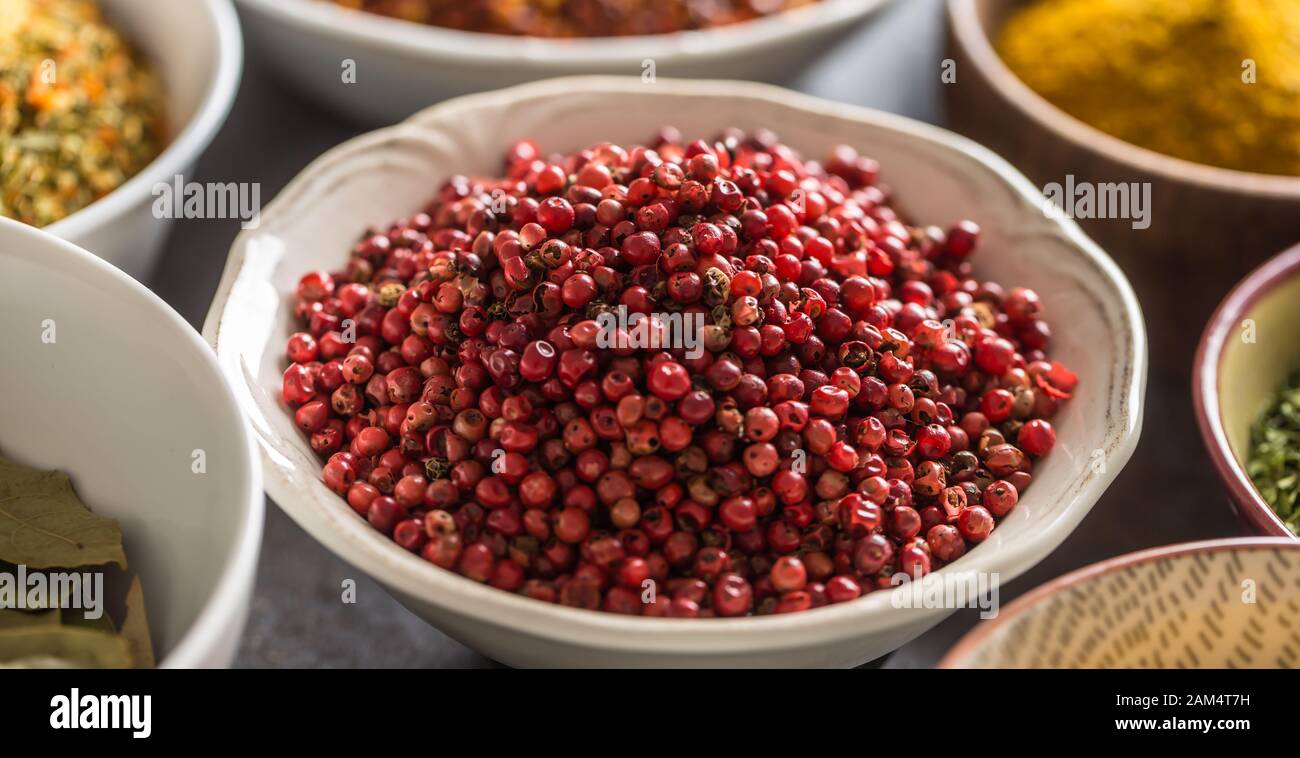 Pink peppercorn and variety spices and herbs in bowls Stock Photo - Alamy