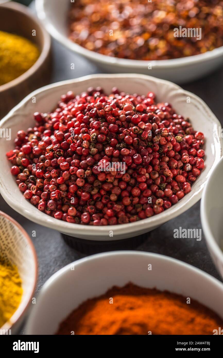 Pink peppercorn and variety spices and herbs in bowls Stock Photo - Alamy