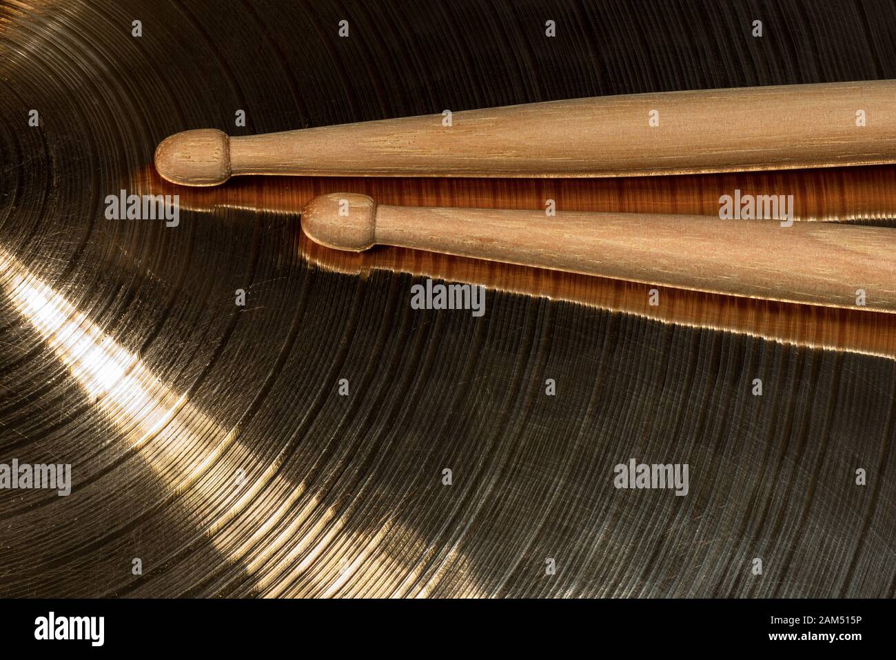 Close-up of a pair of wooden drumsticks on a metal cymbal. Percussion ...