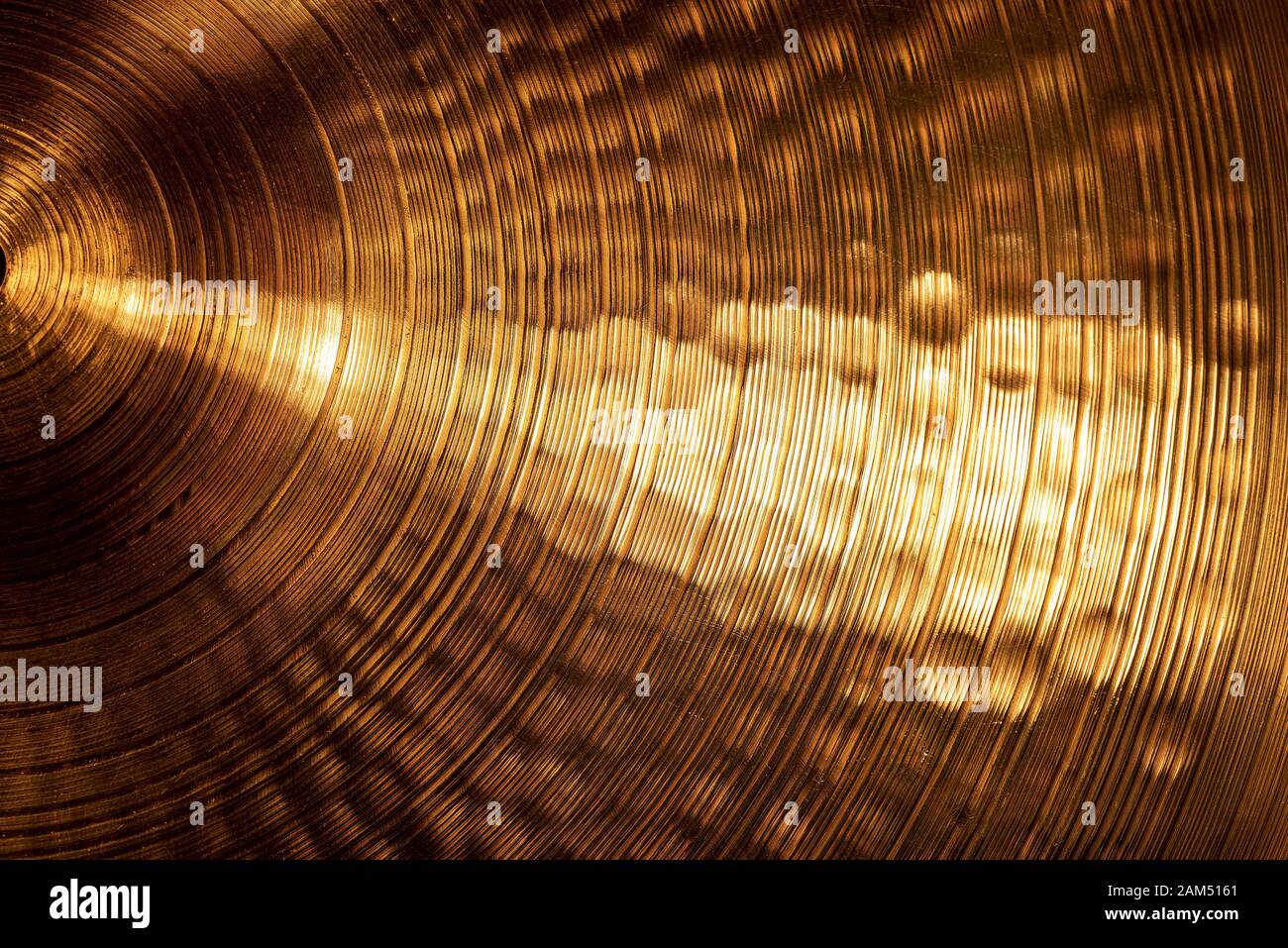 Extreme close-up of an old golden cymbal of drum kit. Percussion ...