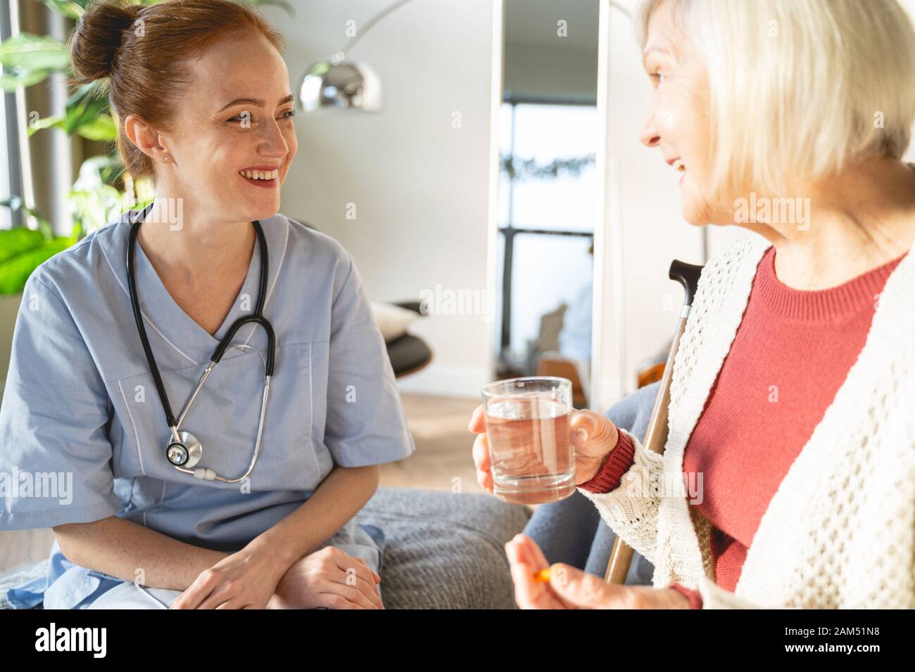 Happy brunette girl working as family doctor Stock Photo - Alamy