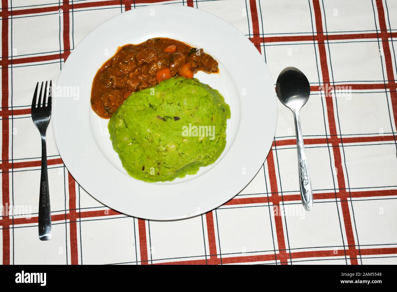 A Plate Of One Of The Kenyan Traditional Food Called Mukimo With A Fork And A Spoon Served On