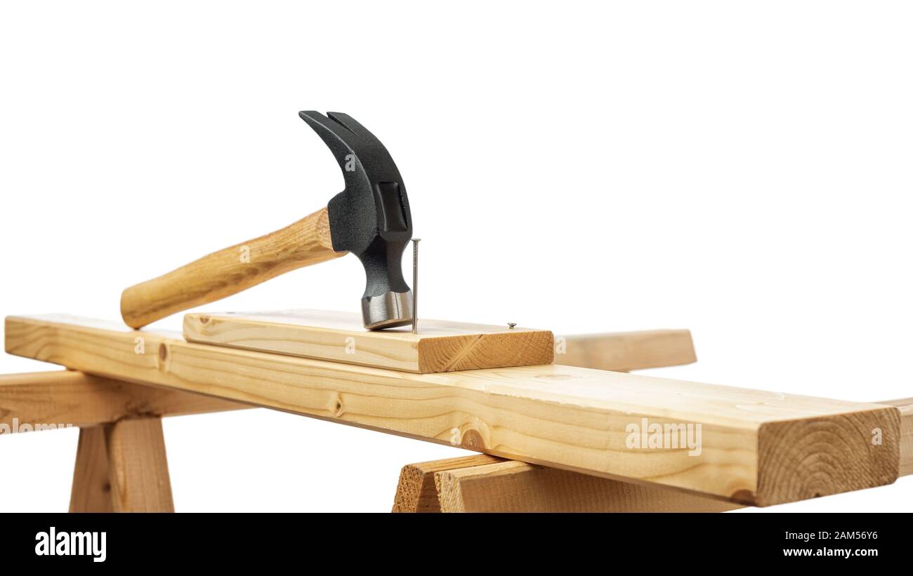 Close-up. Carpenter’s hammer over a wooden board. Construction industry ...