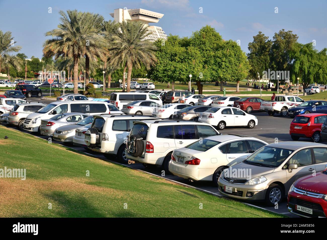Doha, Qatar - Nov 21. 2019. Dallah Parking in park on Corniche street ...