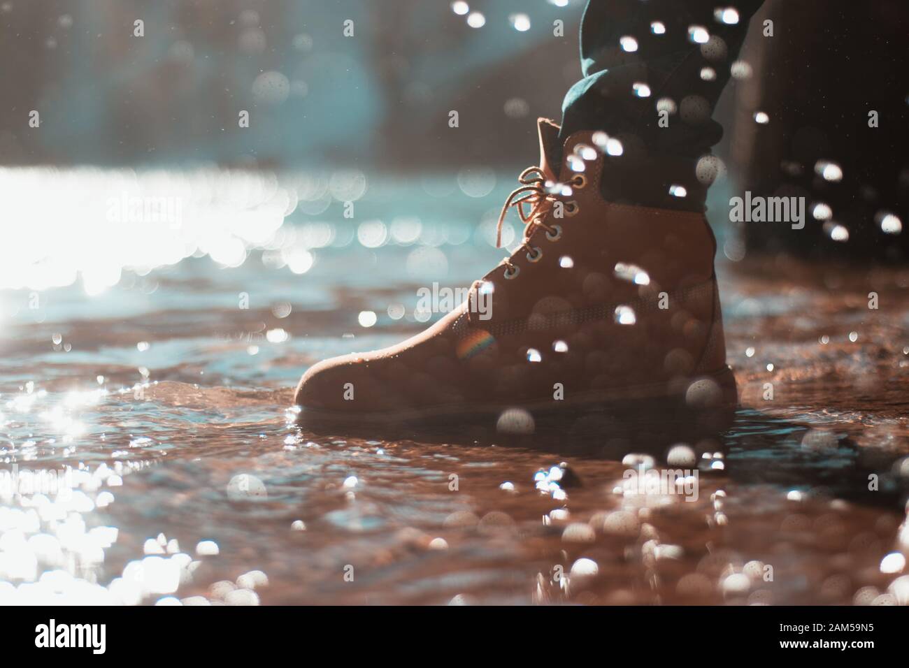 River water splashing on an orange man's boot. Frozen moment , action ...