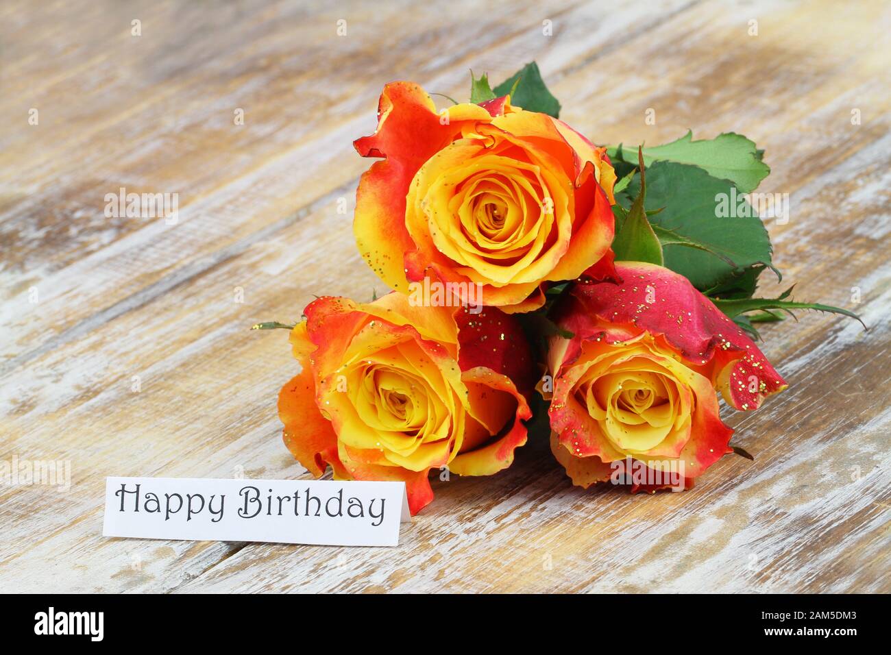 Happy birthday card with three beautiful colorful roses on rustic ...