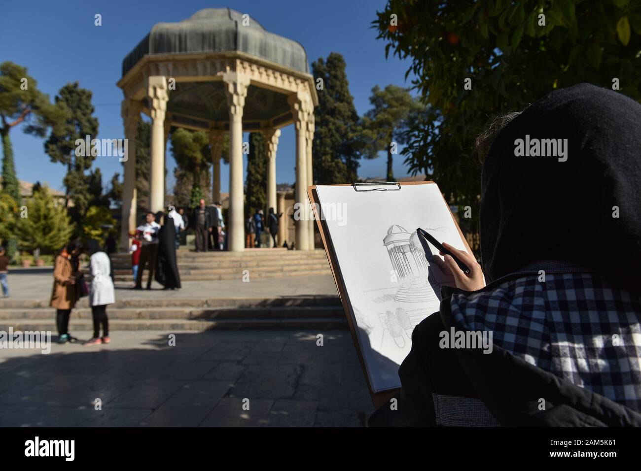 Iran, Shiraz city, Hafezieh. A girl is drawing sketch of Hafez tomb ...