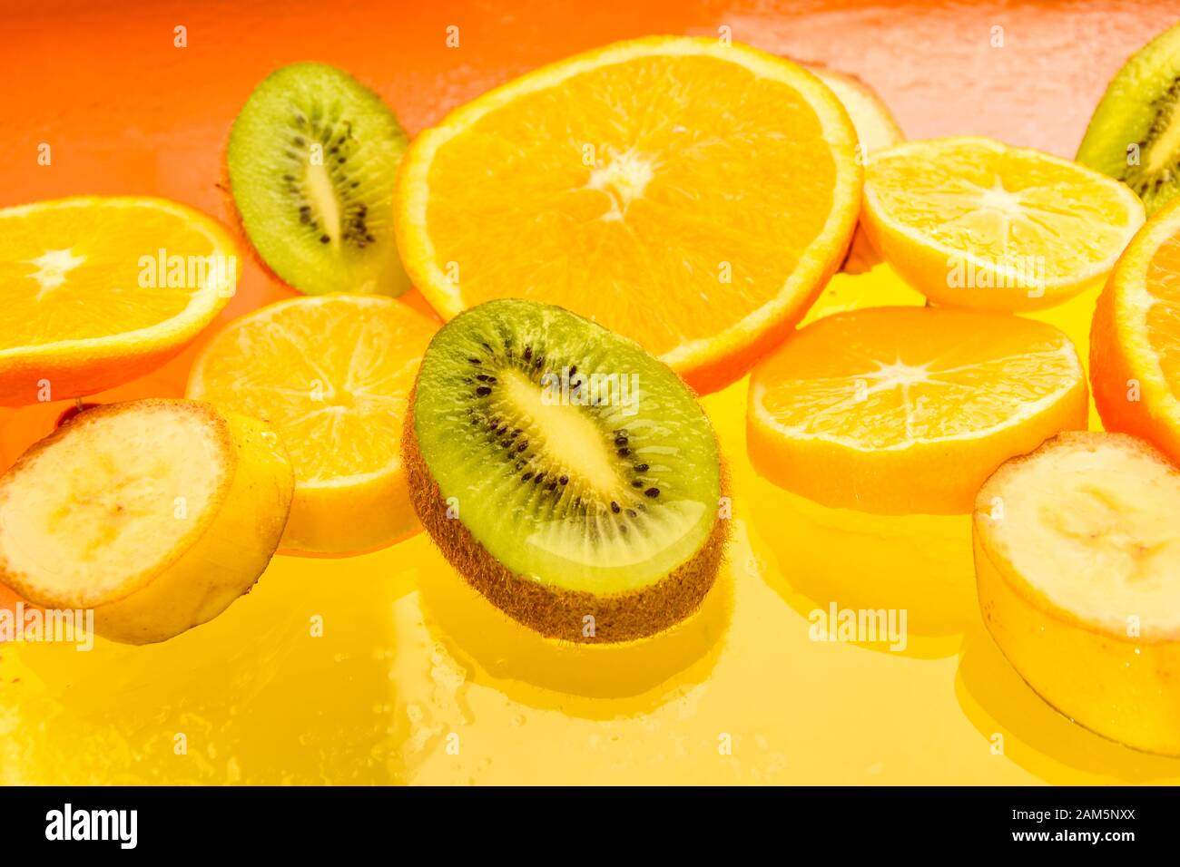 Tropical Fruit slices on the yellow background - stock photo Stock ...