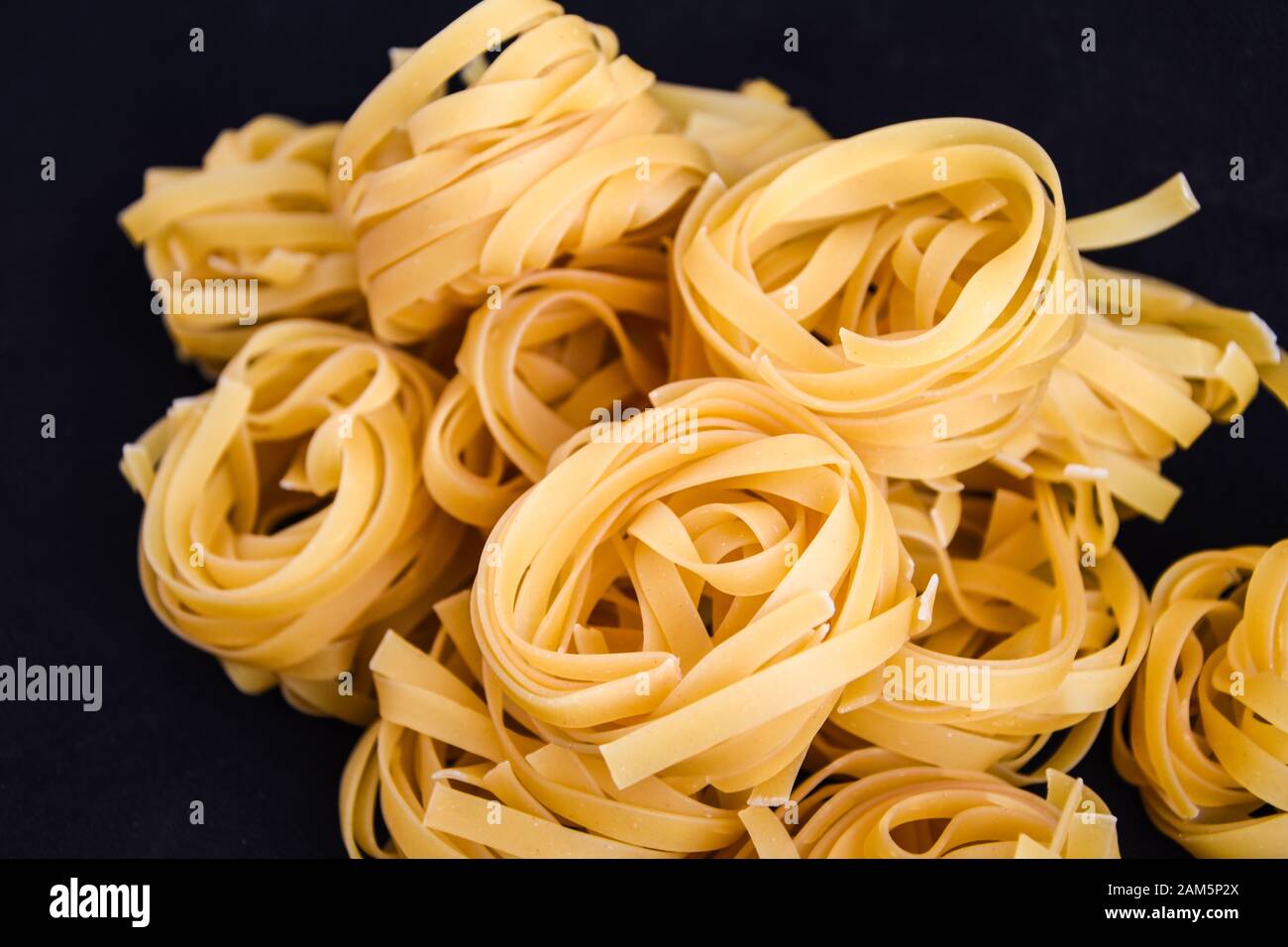 Pasta all'uovo, Tagliatelle Pasta, Round balls of raw pasta on black ...