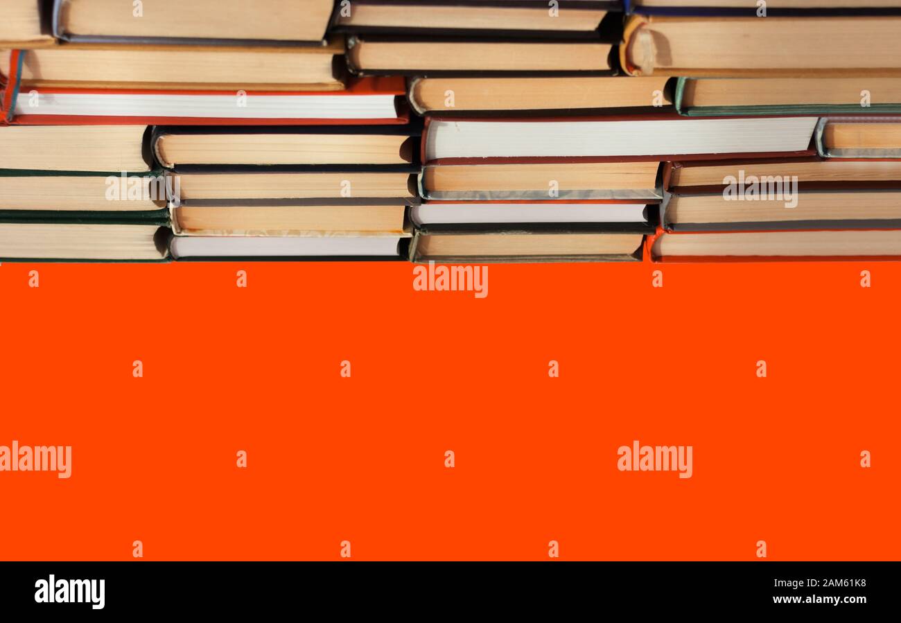 stack of book on red orange lush lava background, education concept ...