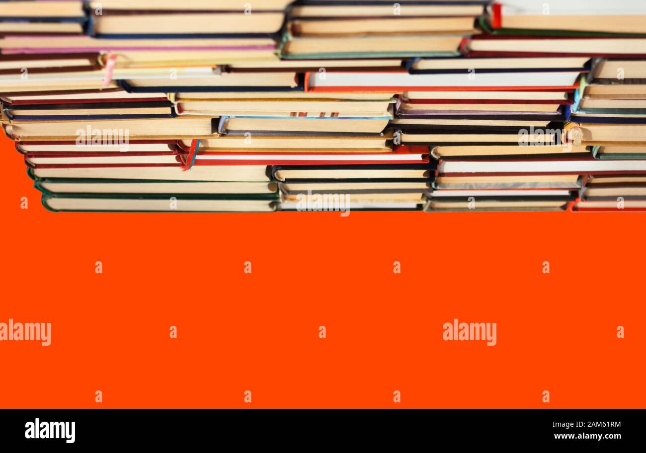stack of book on red orange lush lava background, education concept ...