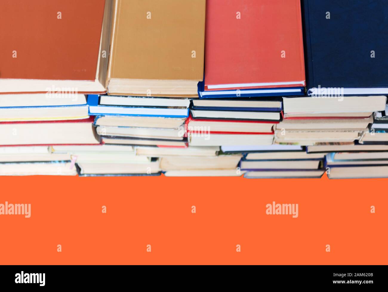 stack of book on red orange lush lava background, education concept ...
