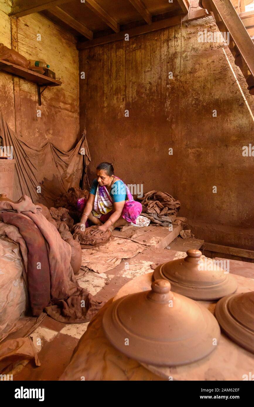 Indian woman prepares clay for making pots in Dharavi Slum at Mumbai ...