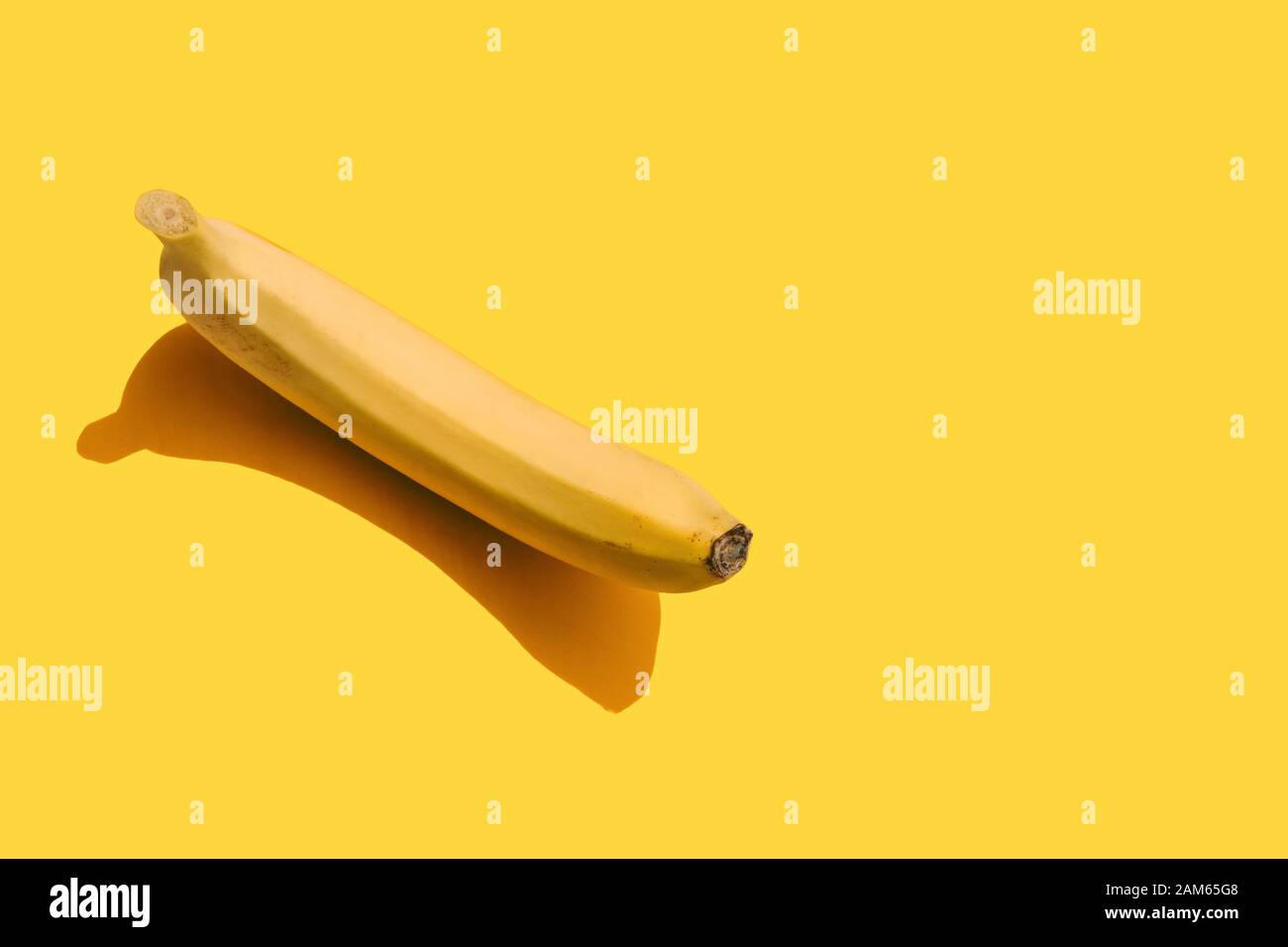 One banana with hard shadow on yellow background with copy space Stock ...