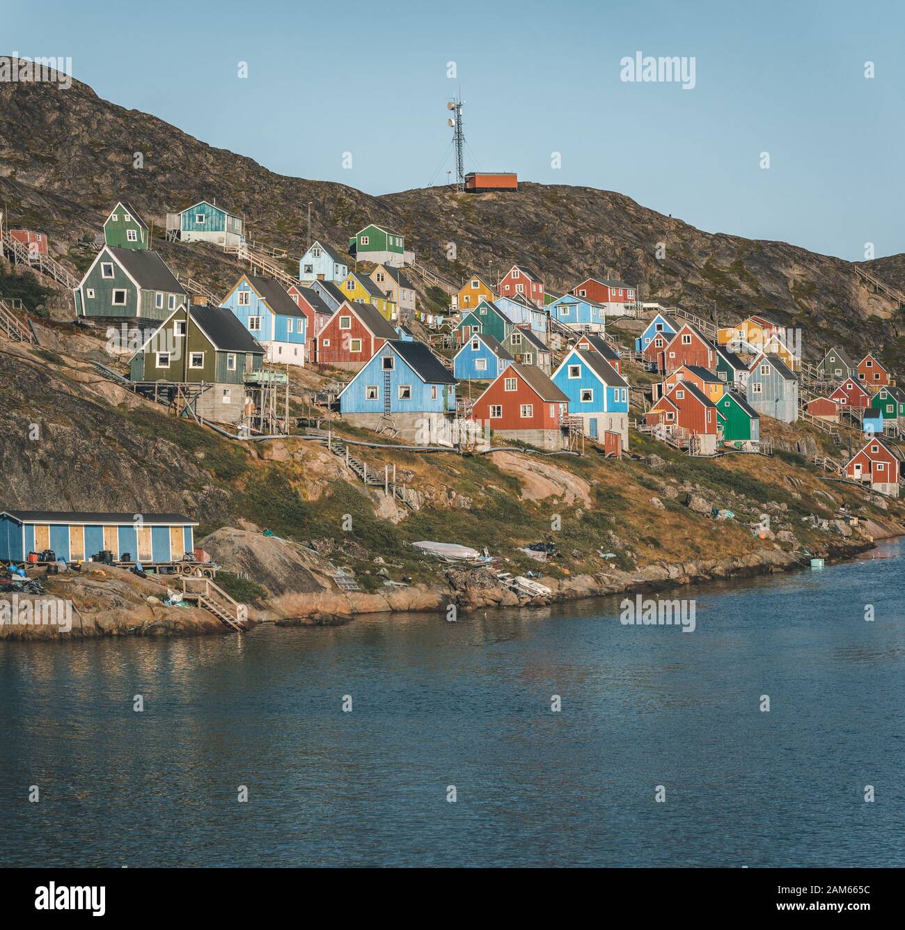 Colorful houses dot the hillsides of the fishing town of Kangaamiut ...